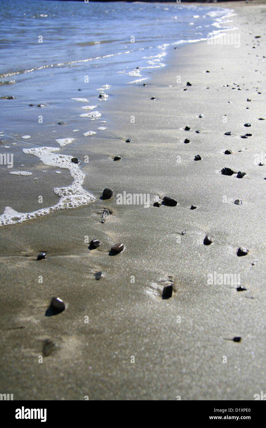 Gray sand beach and gray gravel on the beach in Plimmerton Stock Photo ...