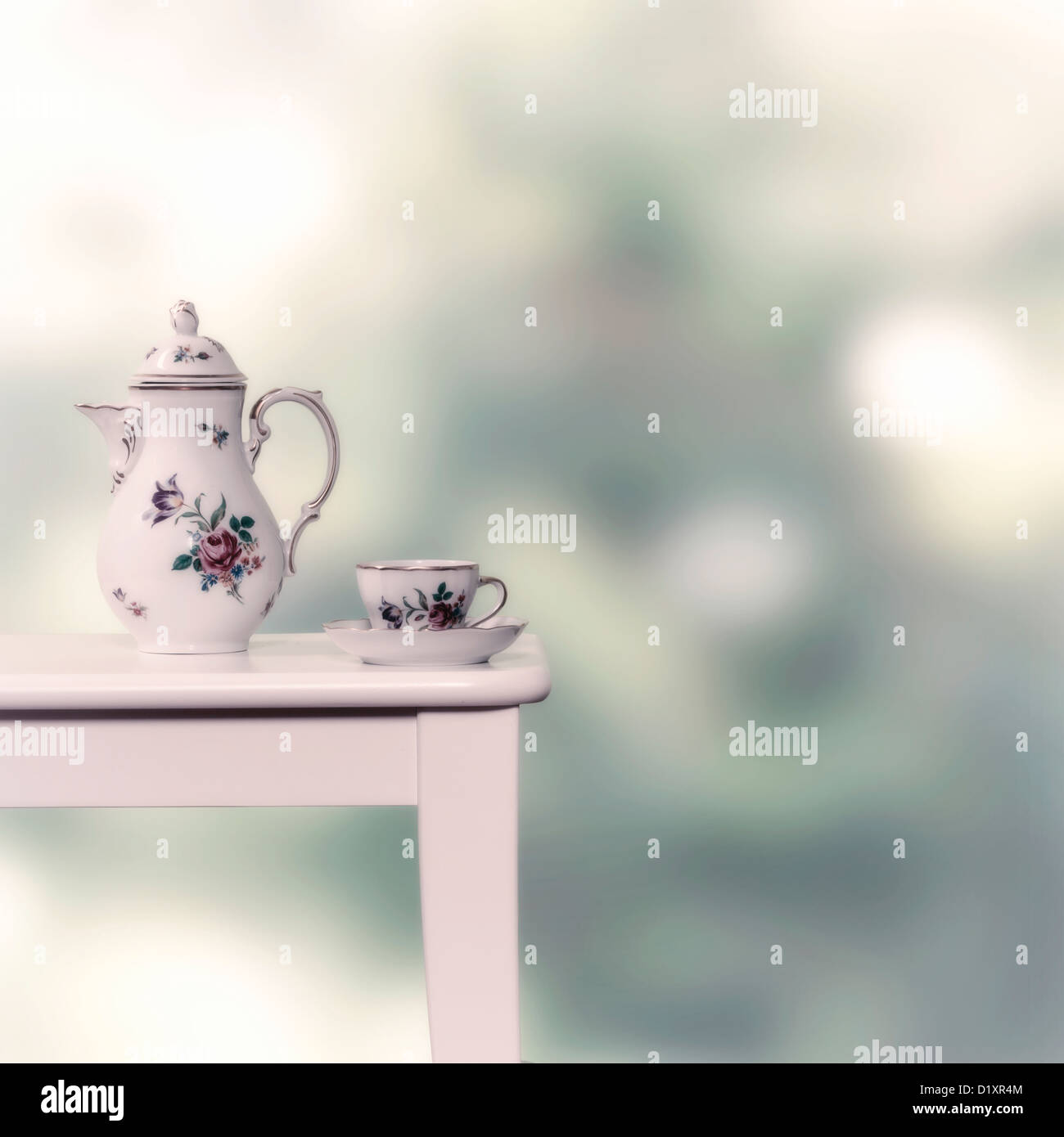 vintage tea pot and cup on a white stool Stock Photo - Alamy