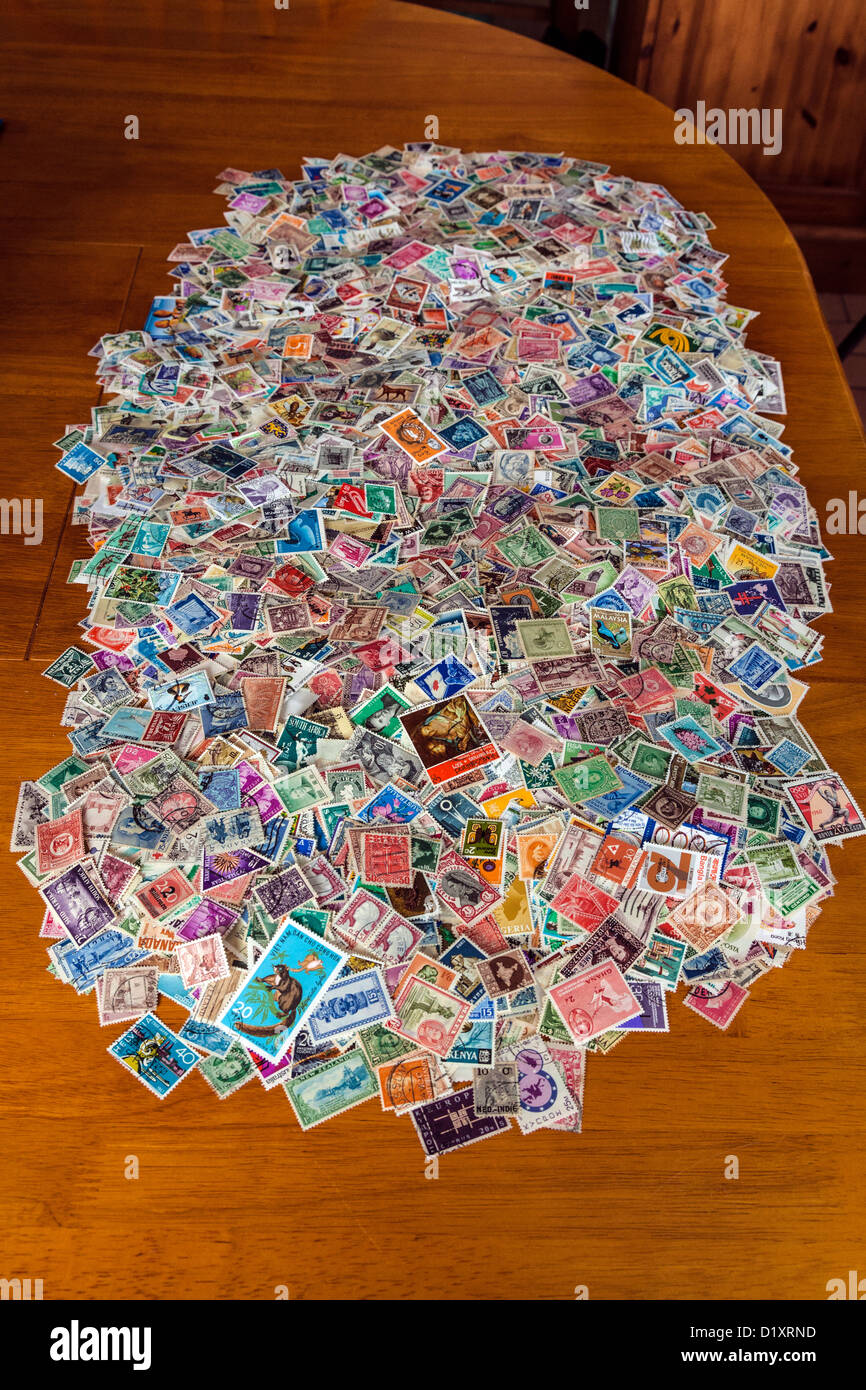 Huge Quantity of Postage Stamps Laid Out on Table Stock Photo - Alamy