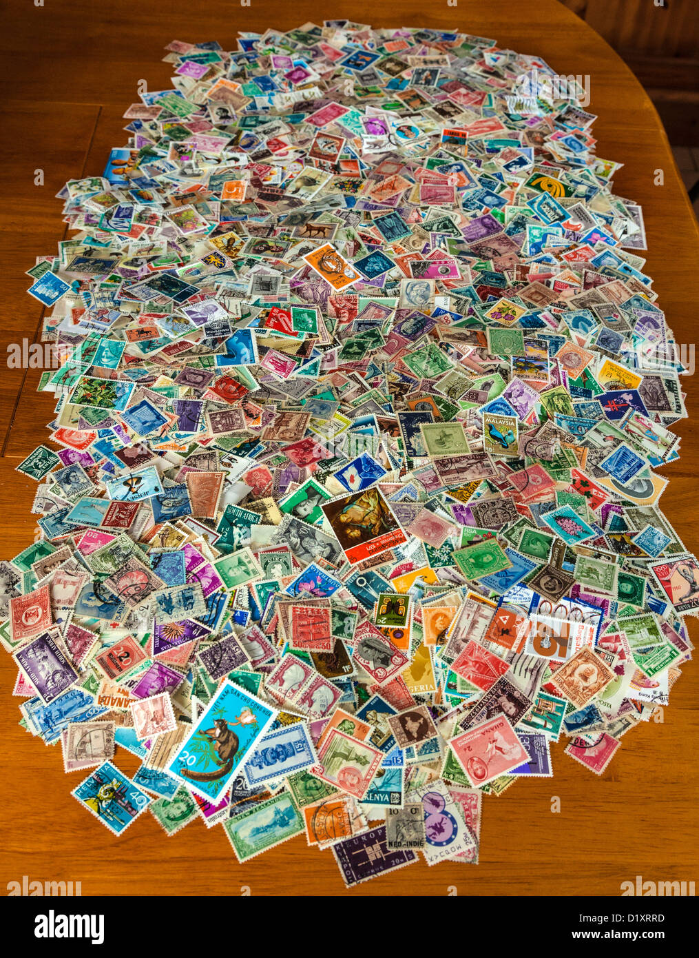 Huge Quantity of Postage Stamps Laid Out on Table Stock Photo - Alamy