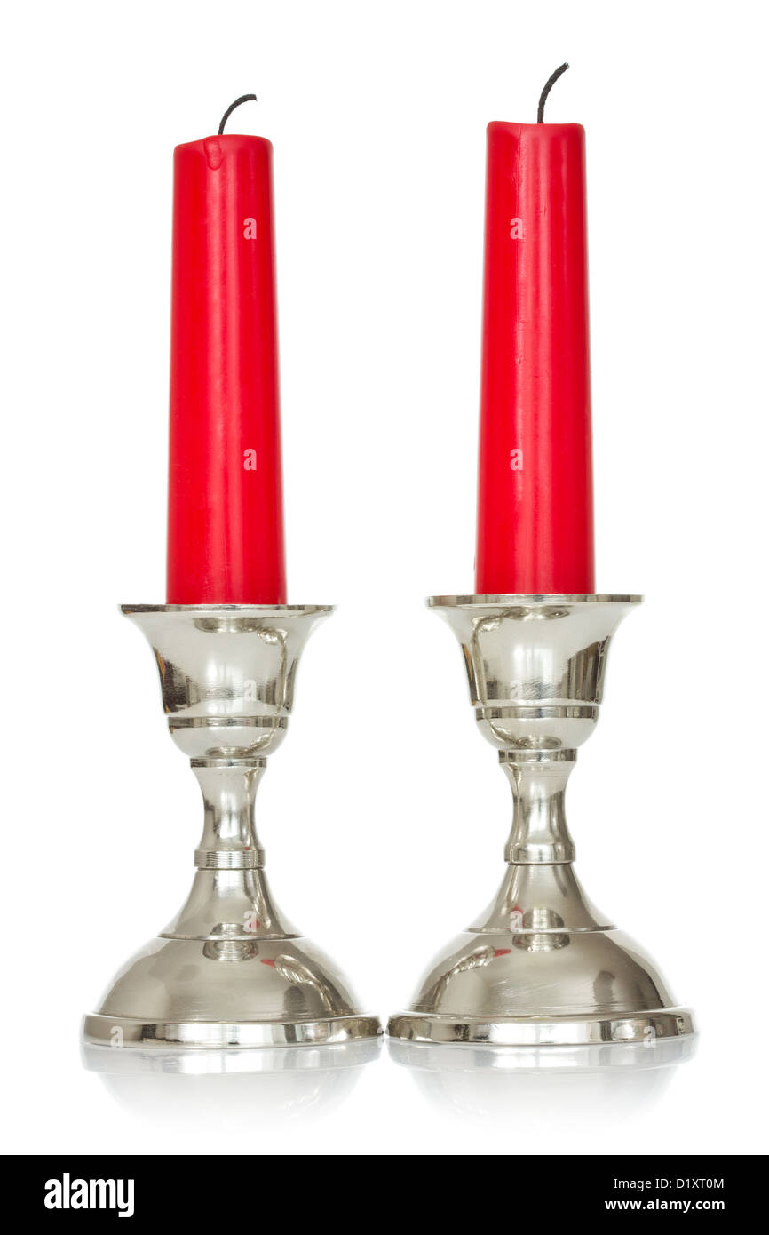 silver plated candlesticks with red candles on white background Stock ...