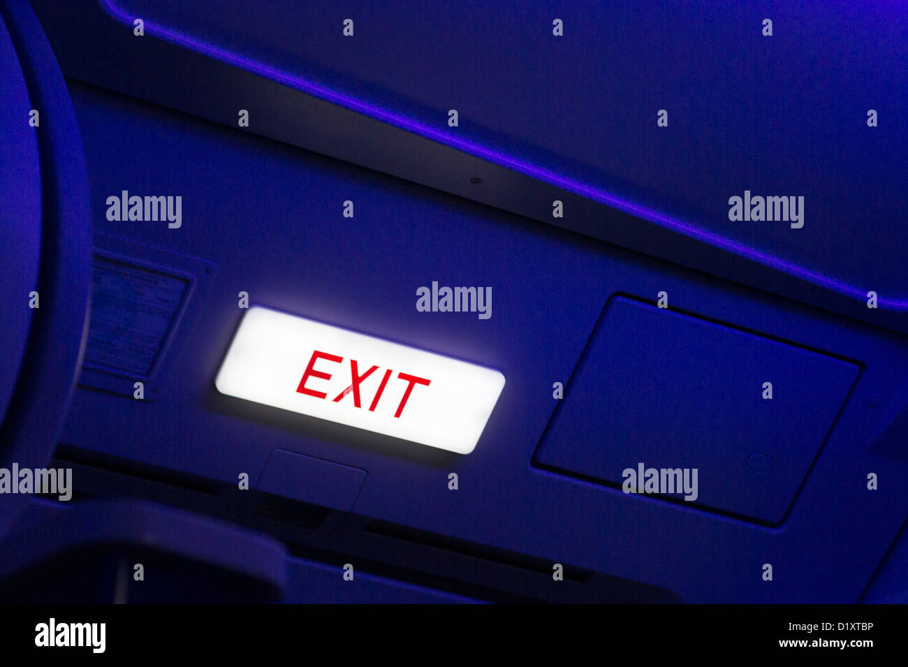 Illuminated exit sign inside an aircraft Stock Photo - Alamy