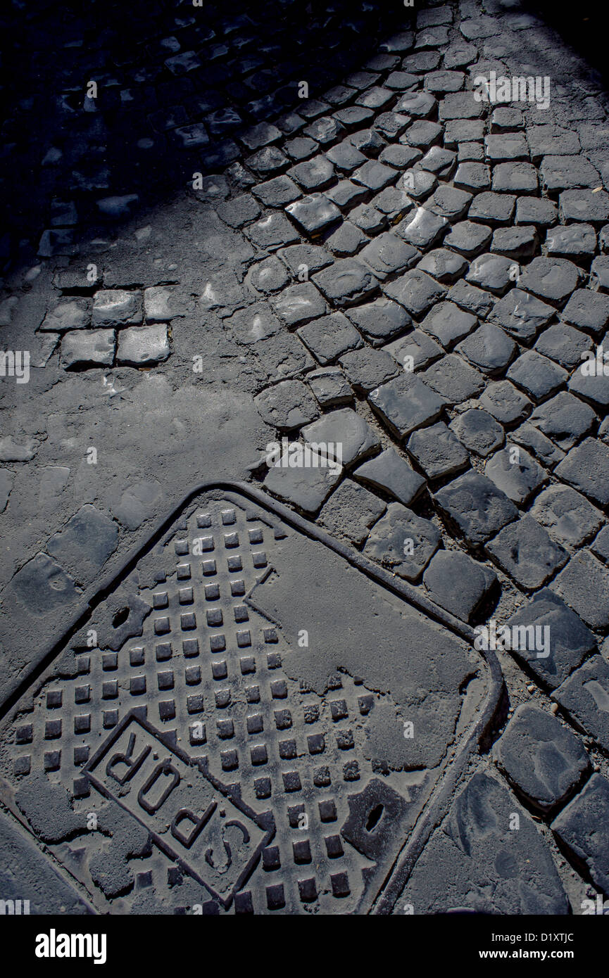 Section of an old cobbled street with drain cover Stock Photo - Alamy