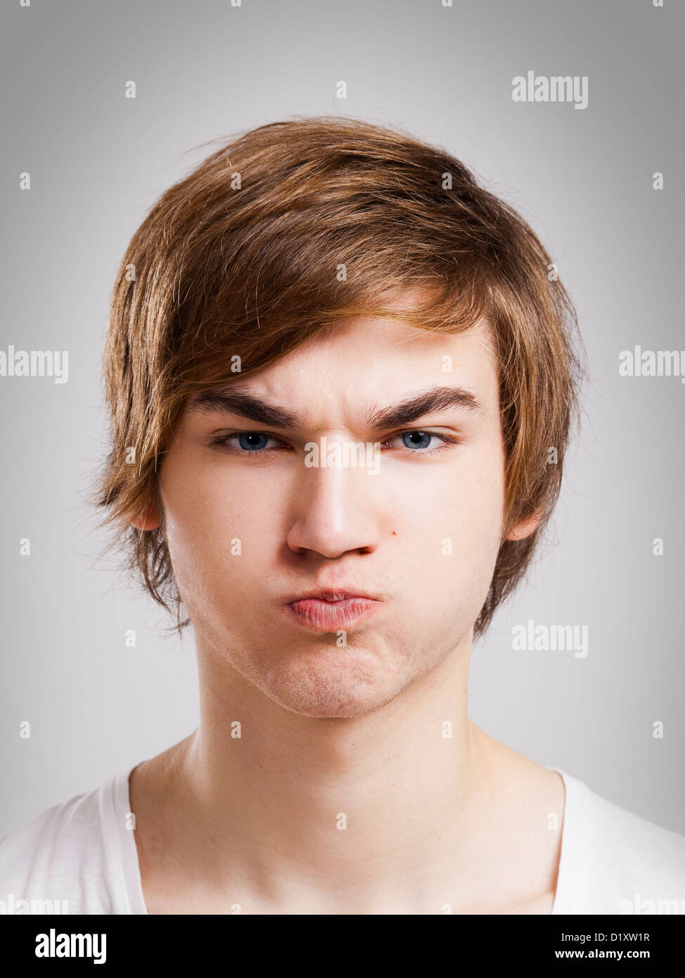 Portrait of a handsome young man, over a gray background Stock Photo ...