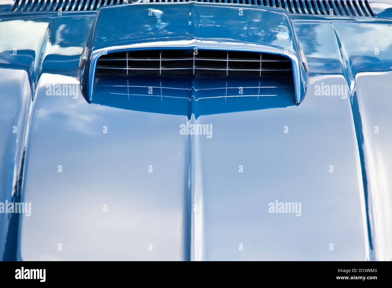 A background image of the blue painted hood of a classic car complete ...