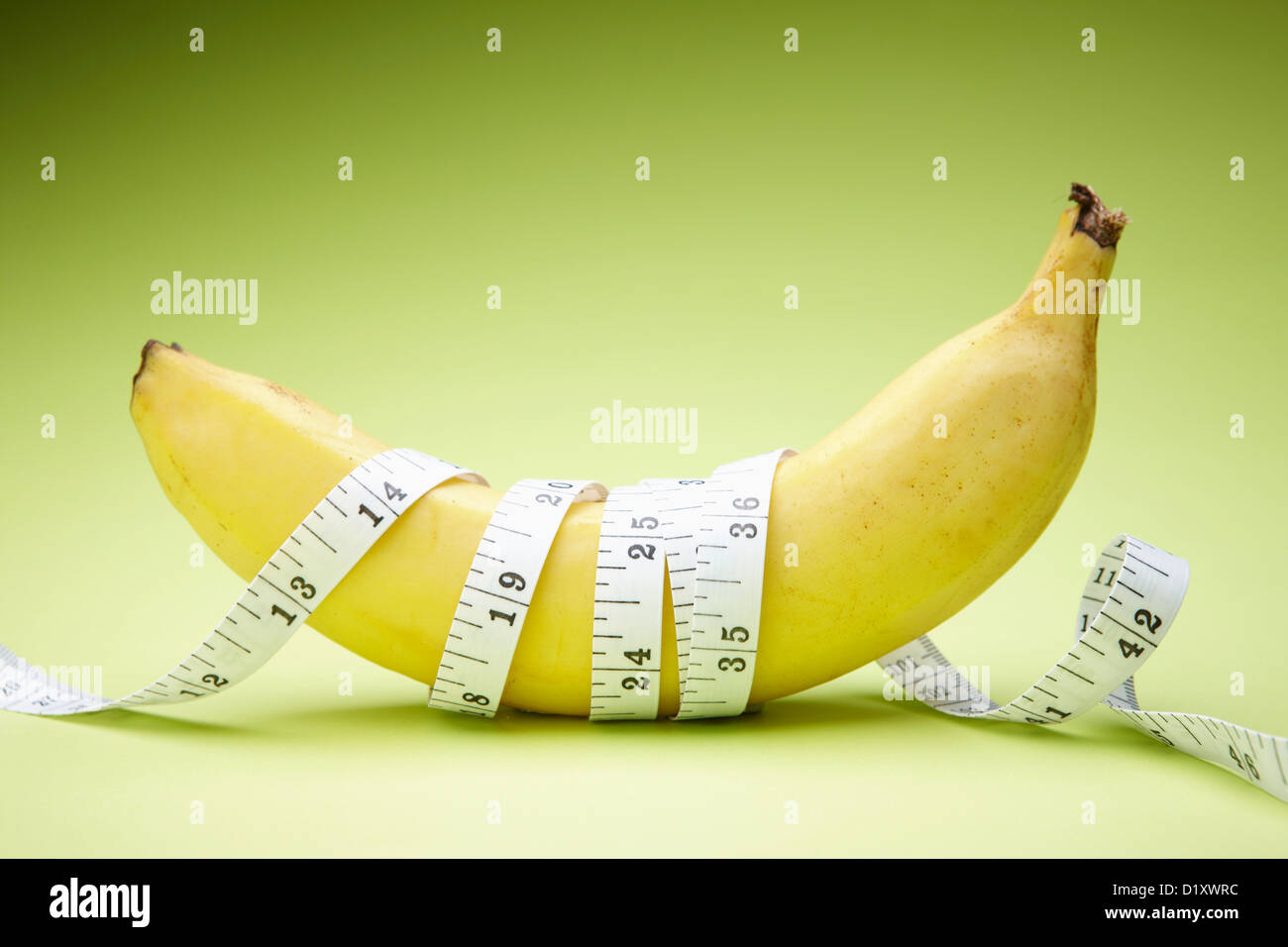 measurement tape surrounding a banana Stock Photo - Alamy