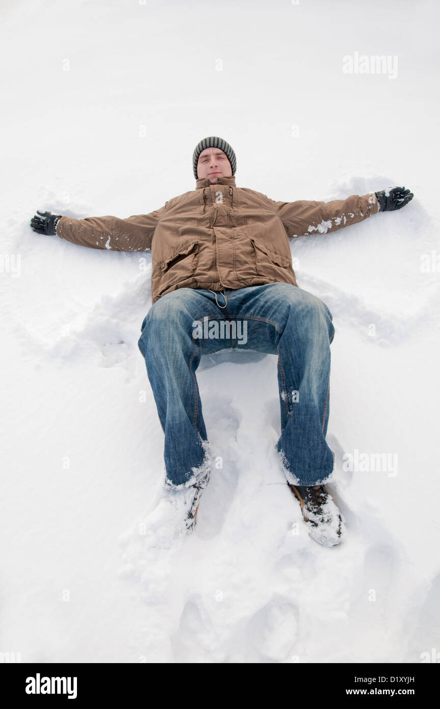An image of man lying on the snow Stock Photo - Alamy
