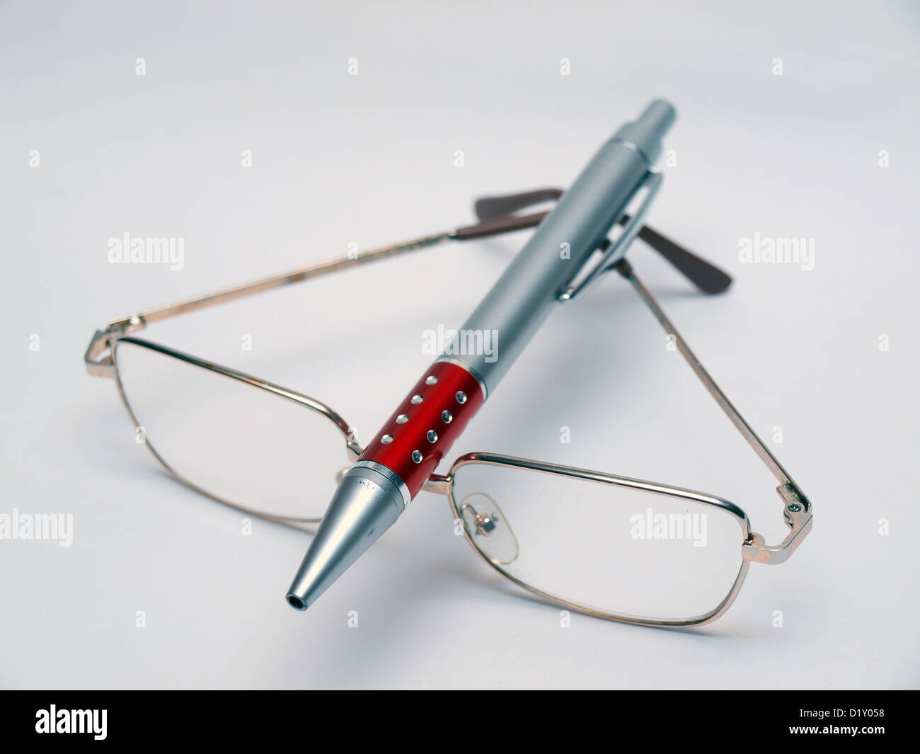 Metal pen on the glasses, looking as eyes and nose Stock Photo - Alamy