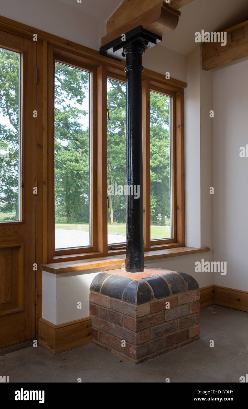 Period cast iron beam being used to support a wooden ceiling beam in a ...