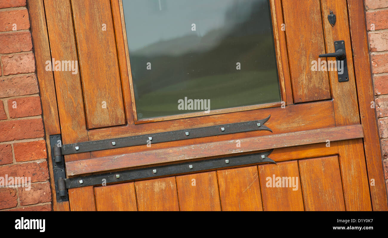 Close up of an iron hinge on a stable door on a new barn conversion ...
