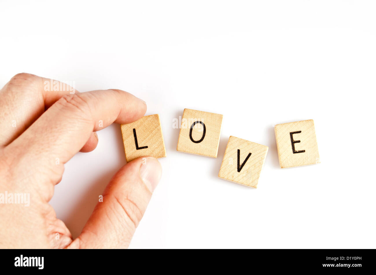 hand composing word love with scrabble tiles Stock Photo - Alamy