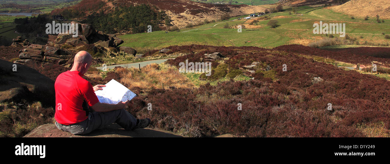 Adult Male walker reading a map by the Sandstone rock formations of the ...