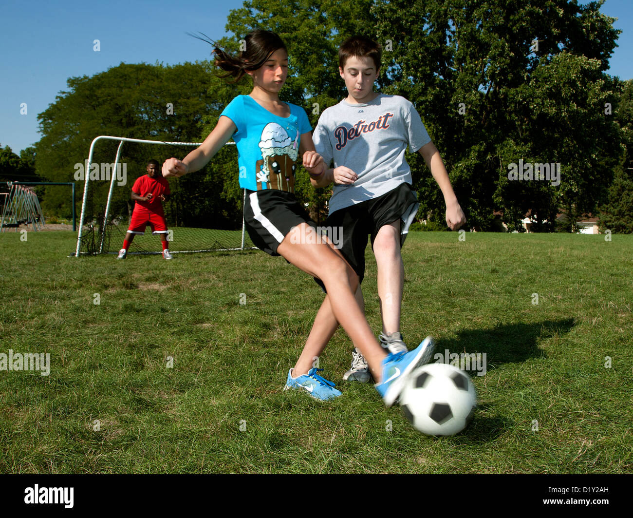 Boy and girl playing soccer Stock Photo - Alamy