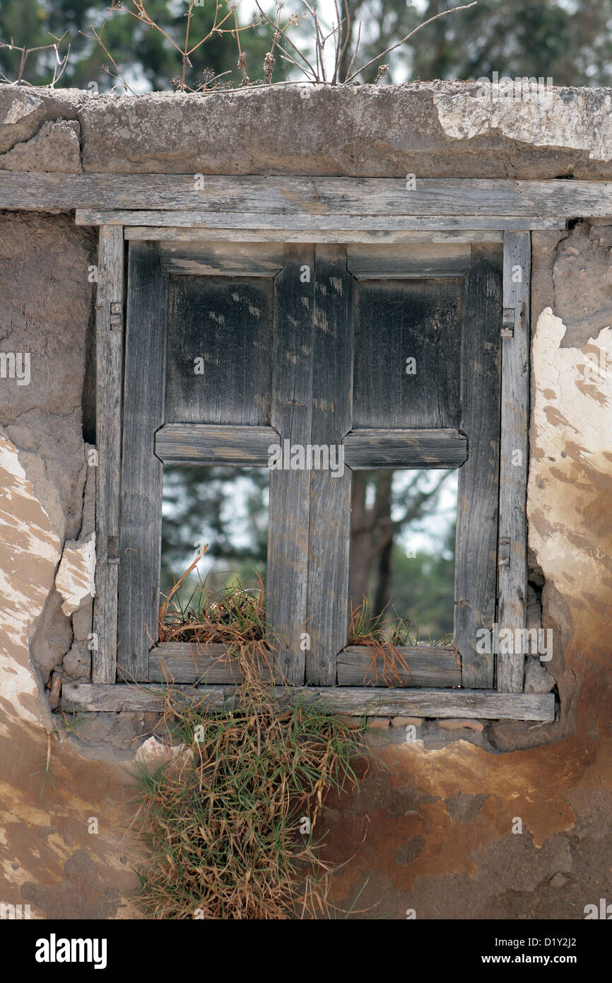 A window with no glass set in the wall of a demolished building in ...