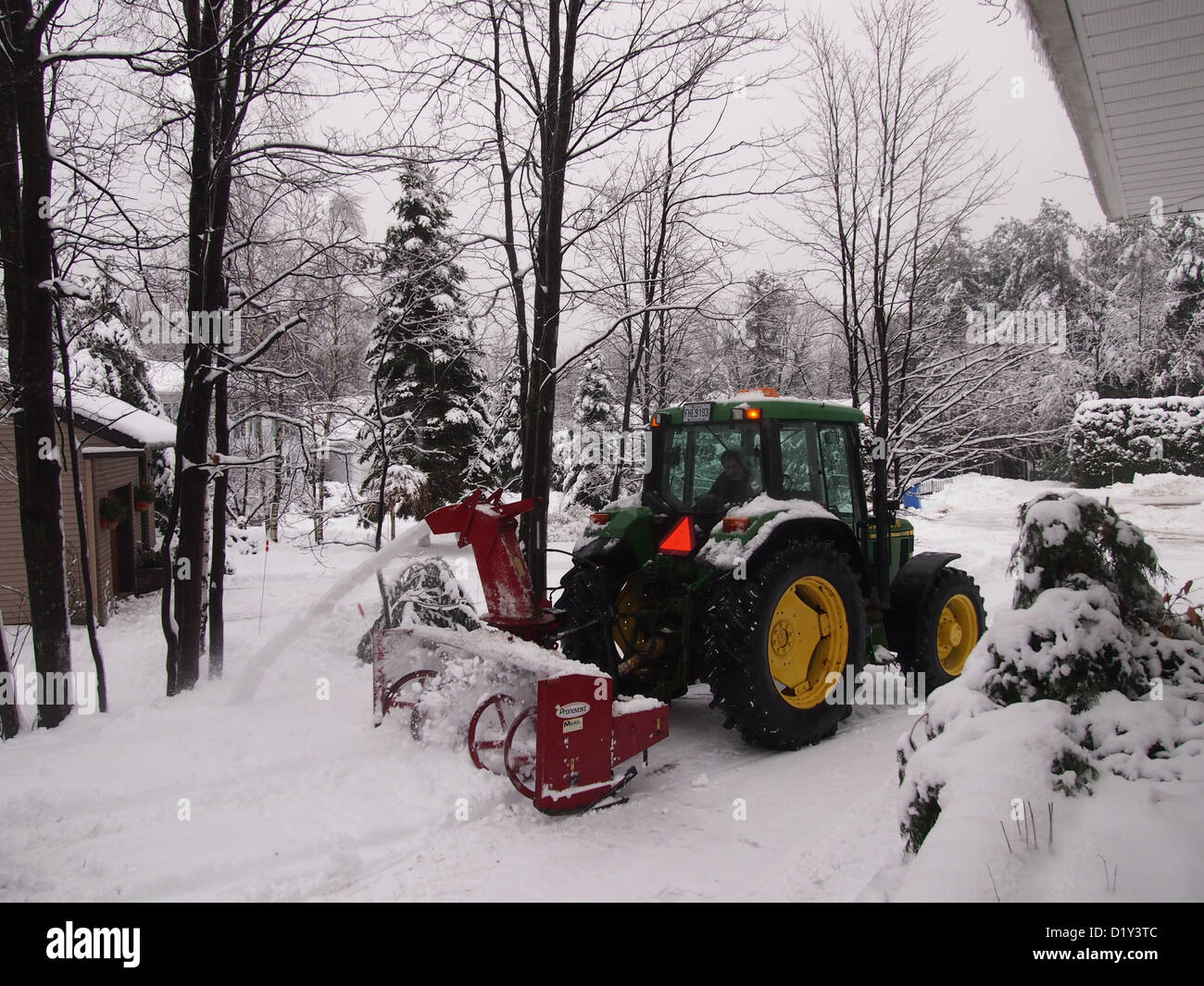 Snow plow and snow blower removing snow in driveway Stock Photo - Alamy