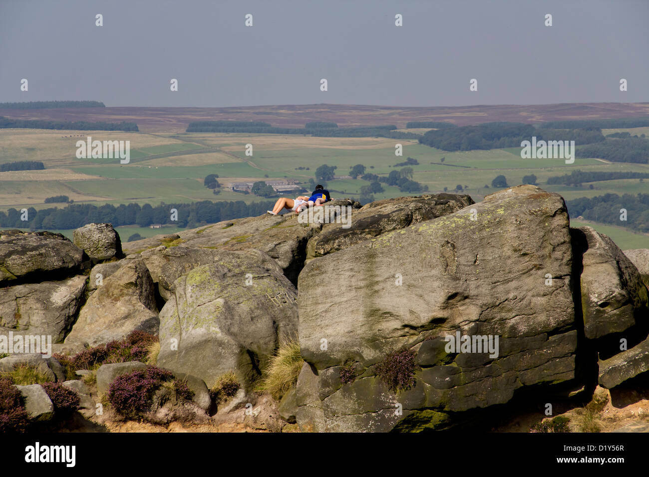 A couple enjoy the view across Wharfedale from the top of the Cow and ...