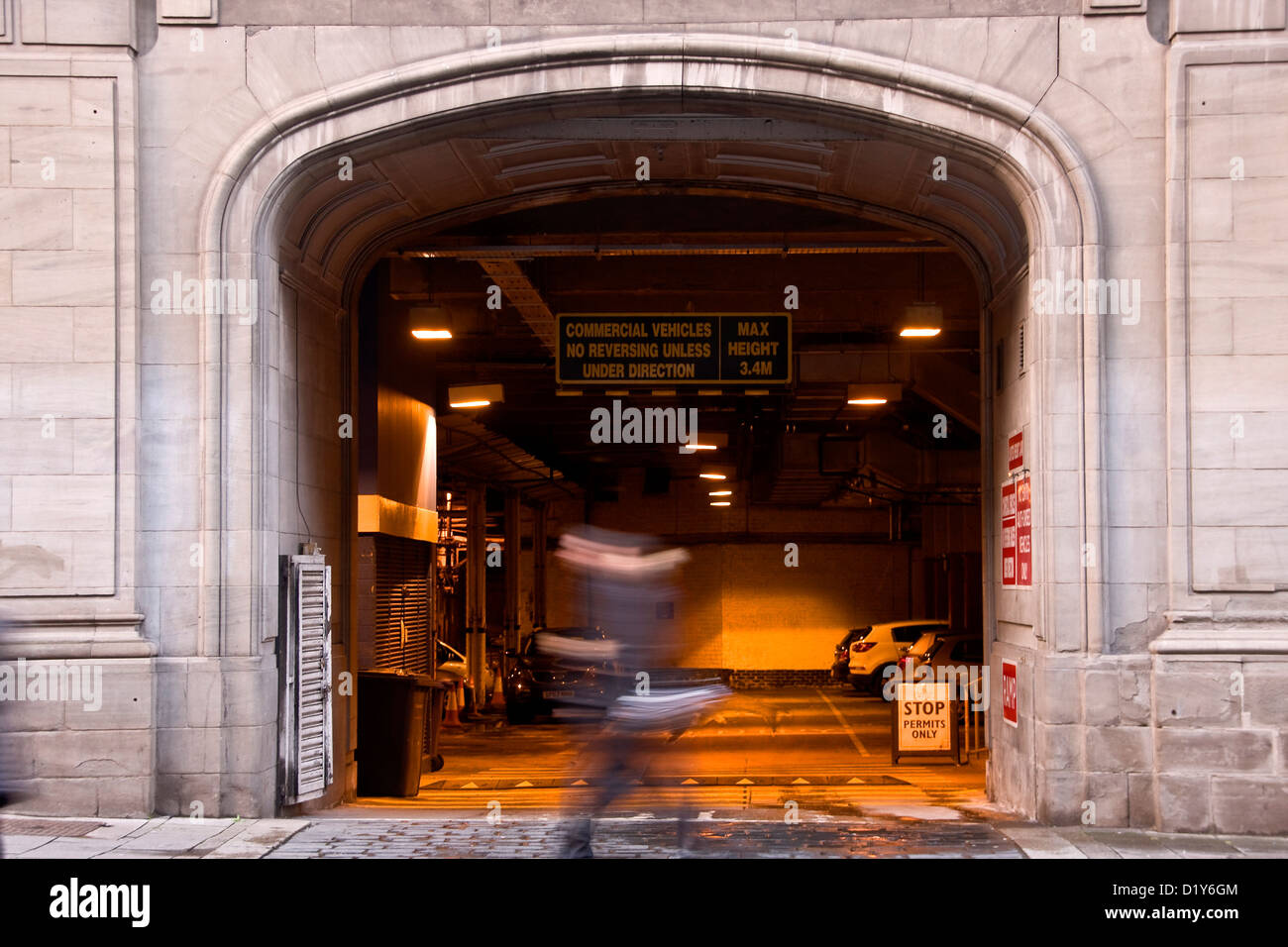 Open doors at the entrance of a basement parking lot with several cars ...