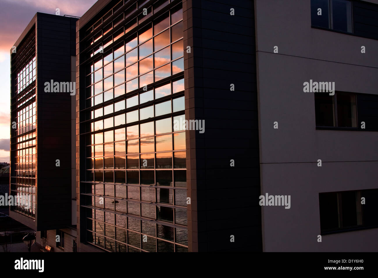 Winter sunset landscape reflecting on the windows of modern office ...