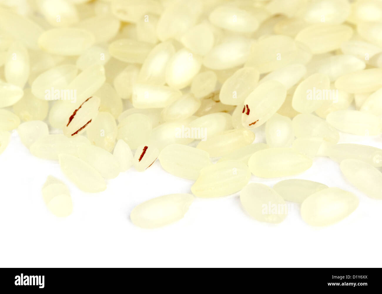 Uncooked rice over white background Stock Photo - Alamy