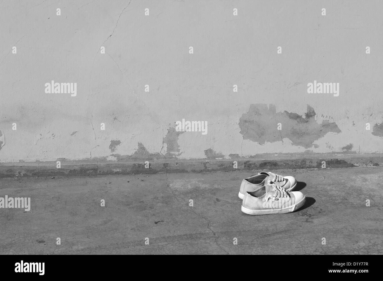 Empty pair of shoes on driveway Stock Photo - Alamy