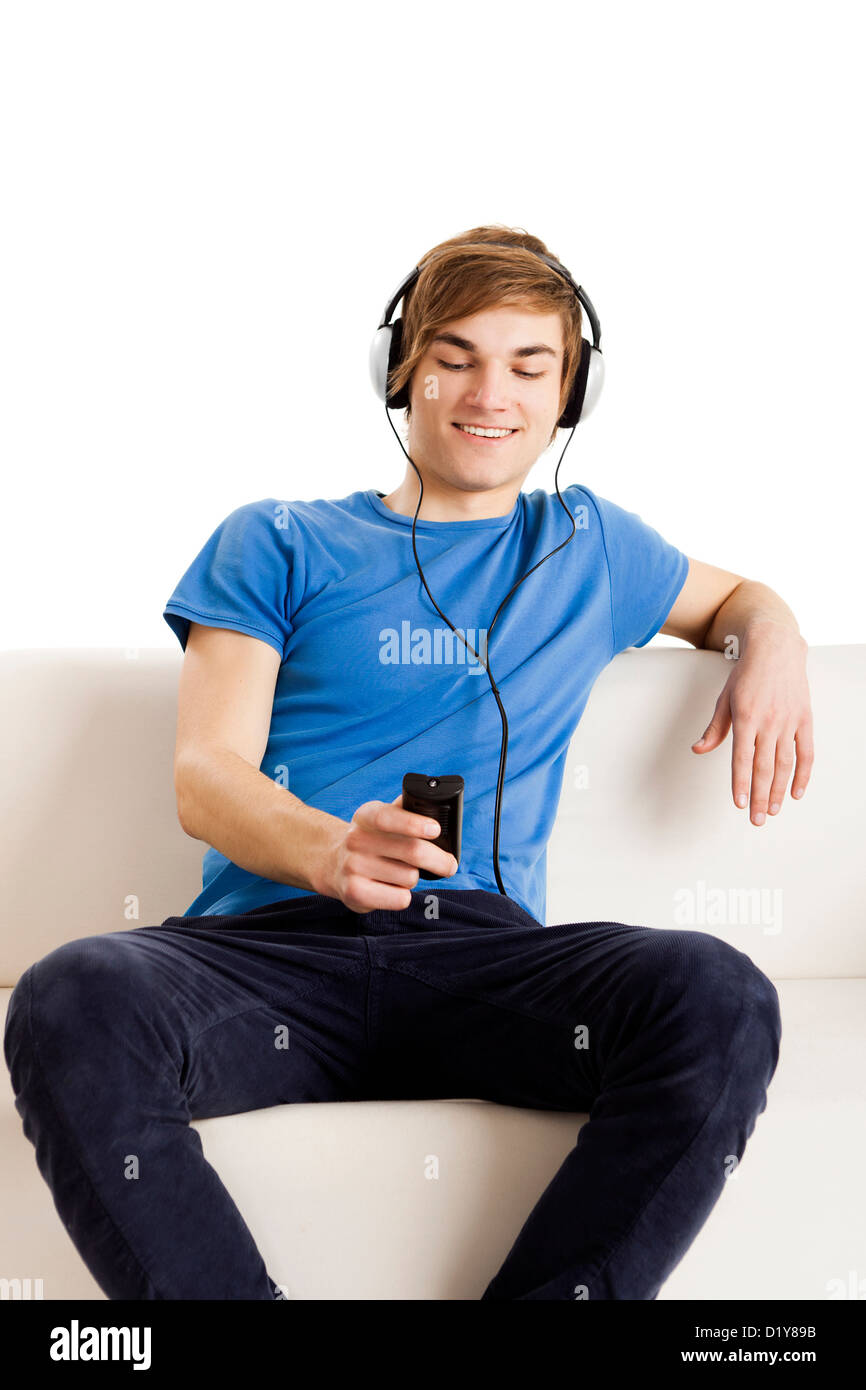 Young man sitting on the couch using a remote control Stock Photo - Alamy