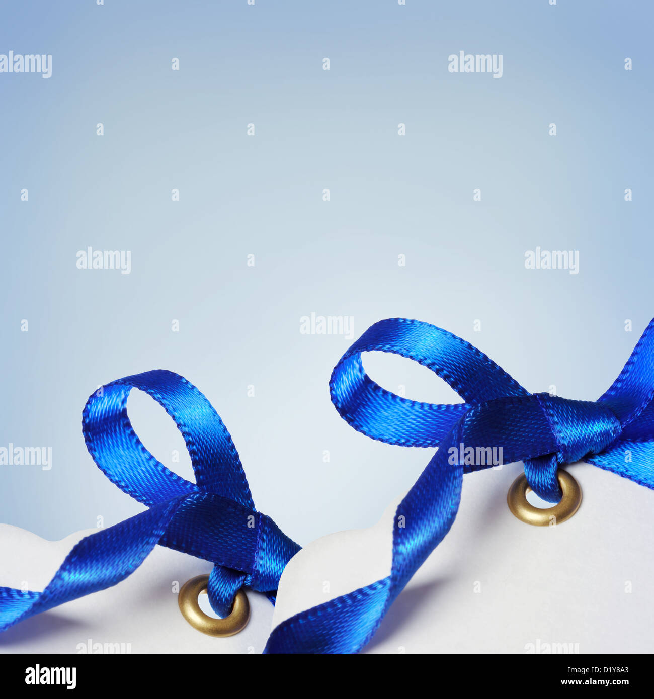 Price Tags with Blue Ribbons on Light Blue Background Stock Photo - Alamy