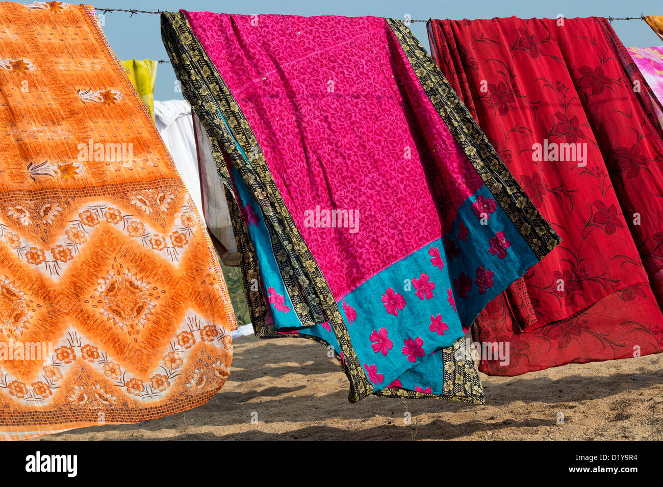 Colourful Indian saris hanging out to dry on a washing line. Andhra ...