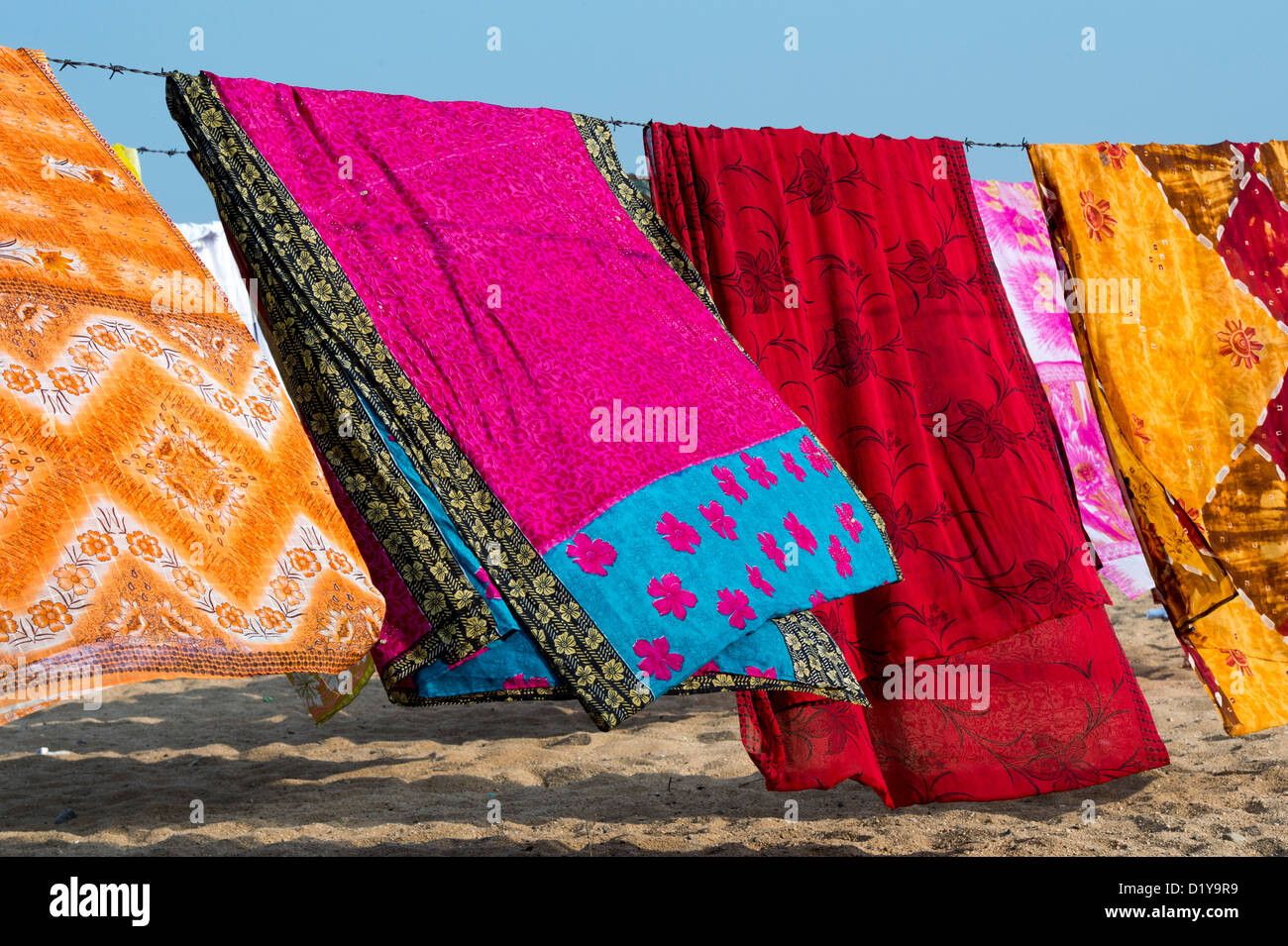 Colourful Indian saris hanging out to dry on a washing line. Andhra ...