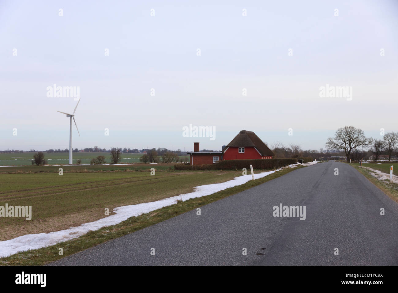Typical scandinavian house and wind turbine nearby, Denmark Stock Photo ...