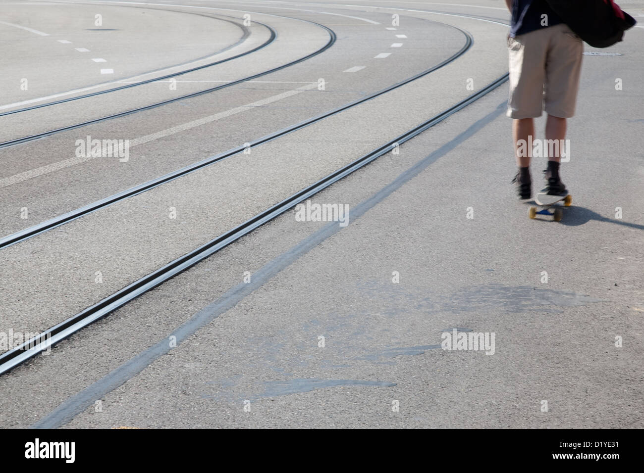 Low Angle Viewpoint of Tram Tracks and Street with Skateboarder Stock ...