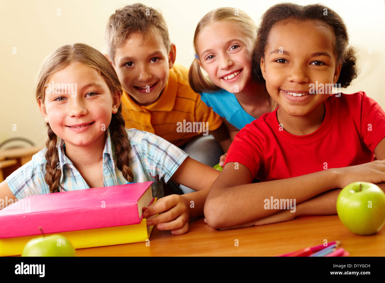 Portrait of smart schoolchildren looking at camera in classroom Stock ...