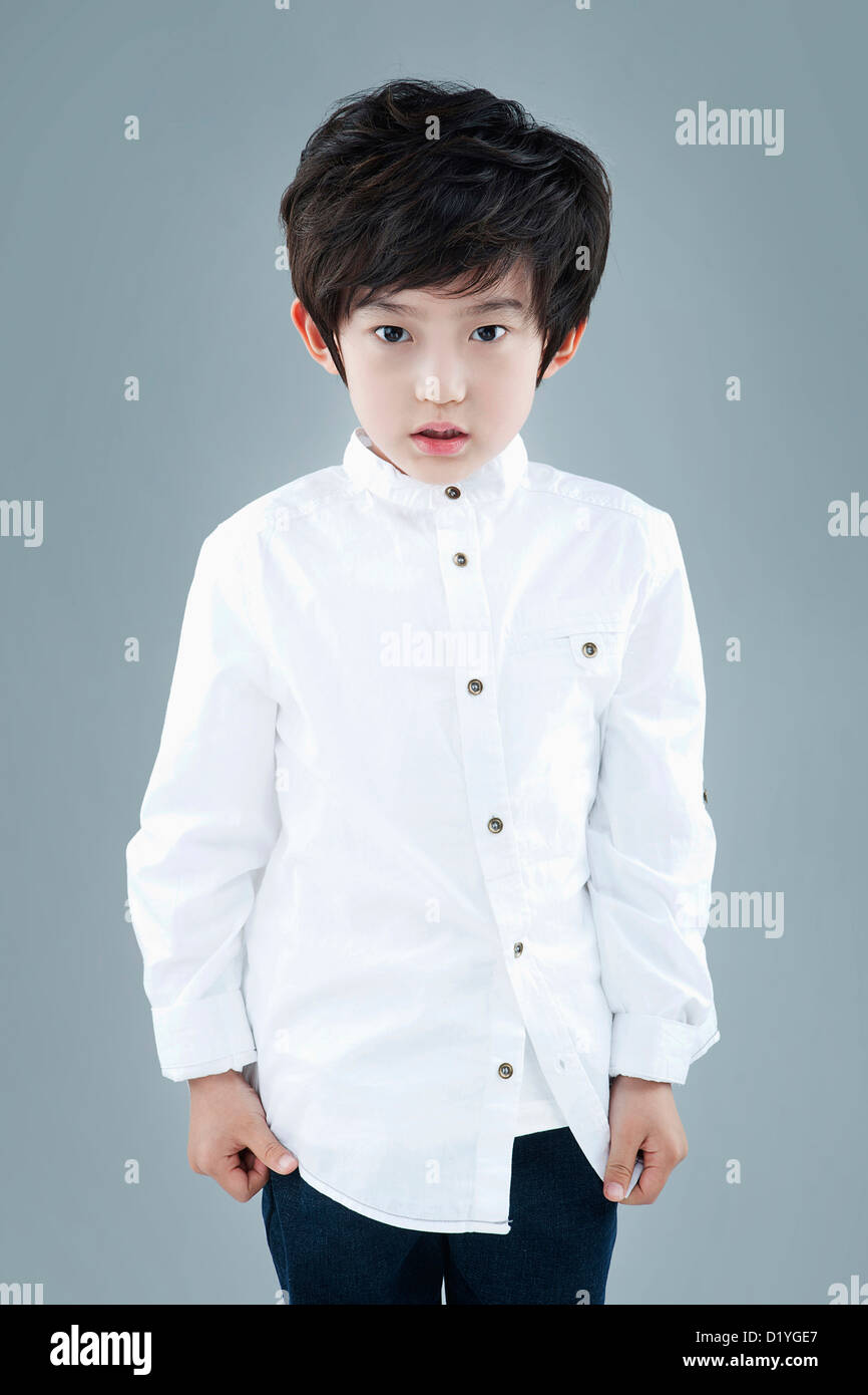 a boy in white shirt standing Stock Photo - Alamy