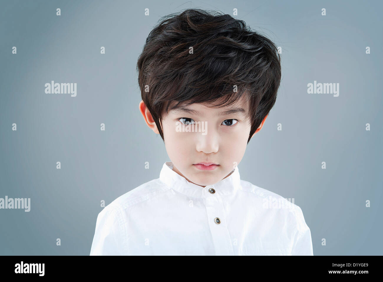 a boy in white shirt staring Stock Photo - Alamy