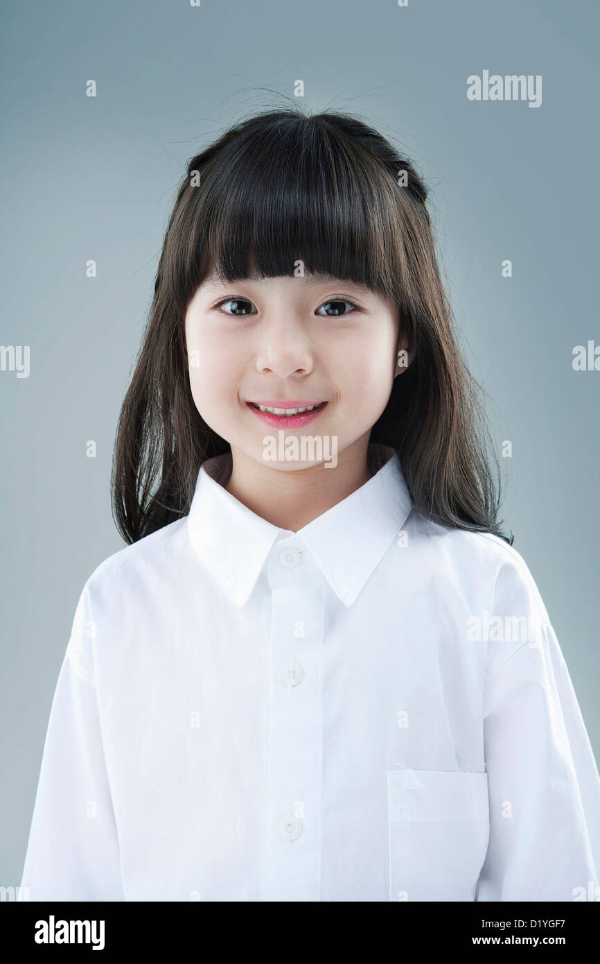 a girl in white shirt smiling Stock Photo - Alamy