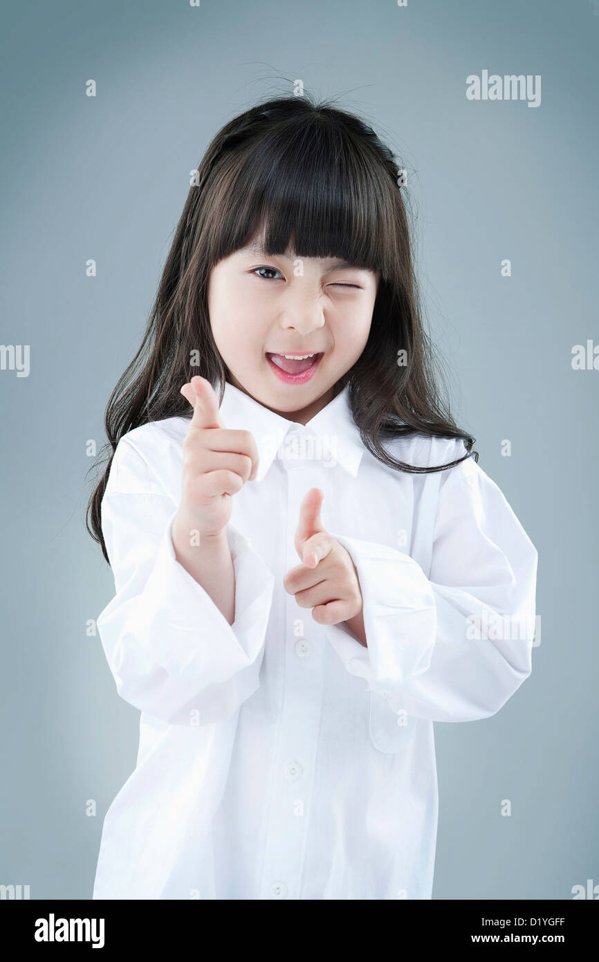 a girl posing while winking Stock Photo - Alamy
