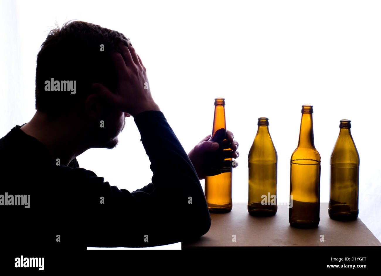 Silhouette of a man with a beer bottle. Strong contrast, cold blueish ...
