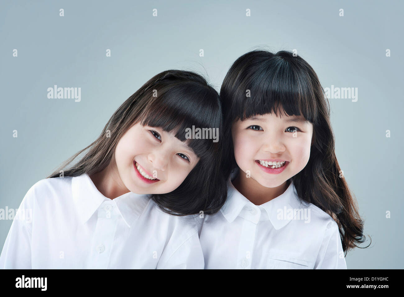two female kids smiling together Stock Photo - Alamy