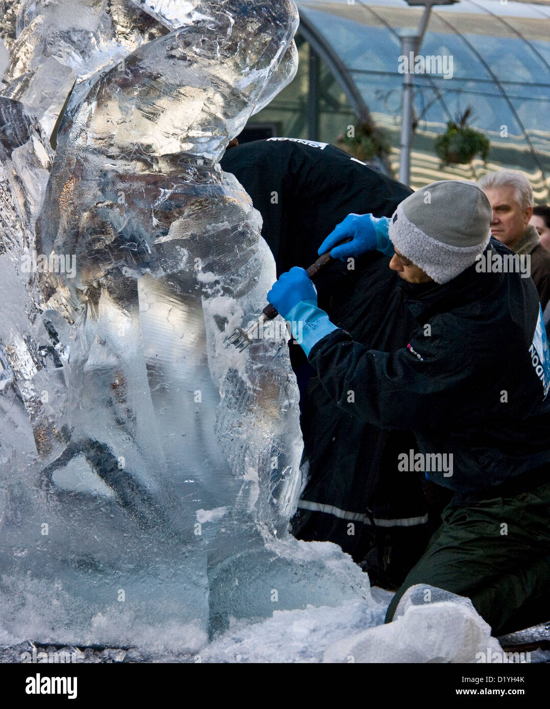 Man sculpting ice with chisel Ice Sculpting Festival Canary Wharf ...