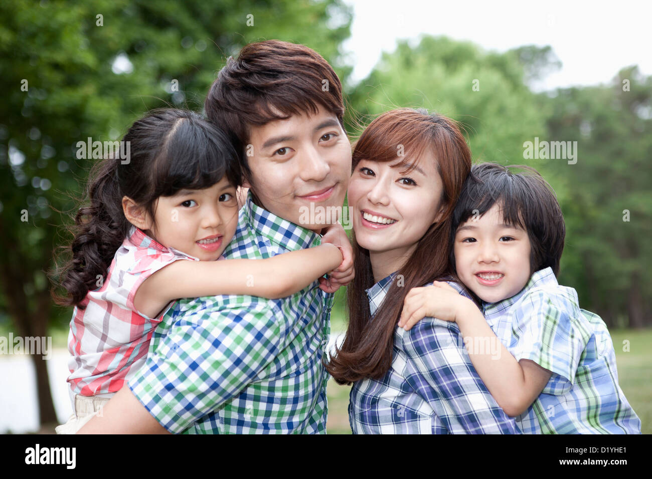 parents posing with kids in their back Stock Photo - Alamy
