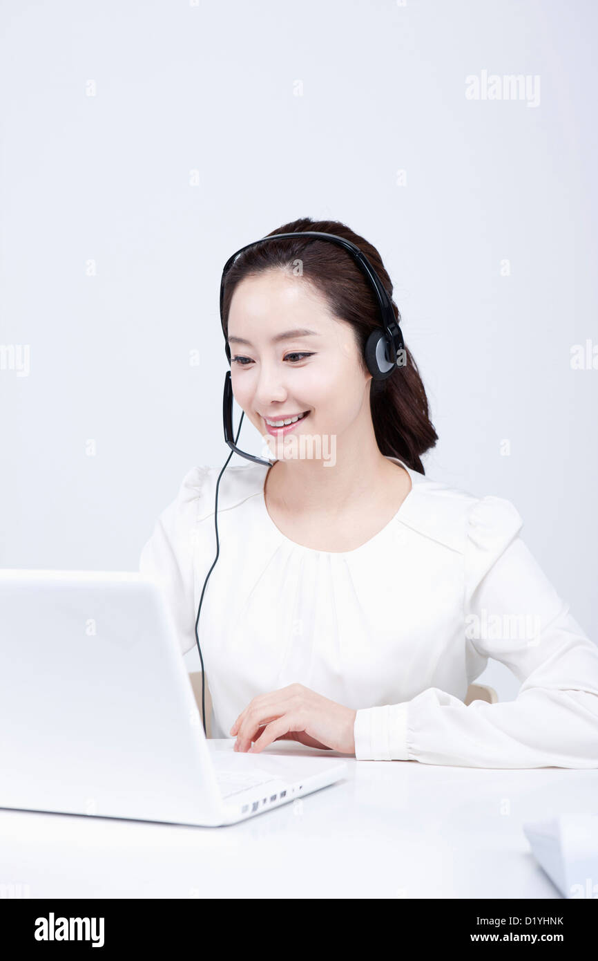 a telemarketer working with a white laptop Stock Photo - Alamy