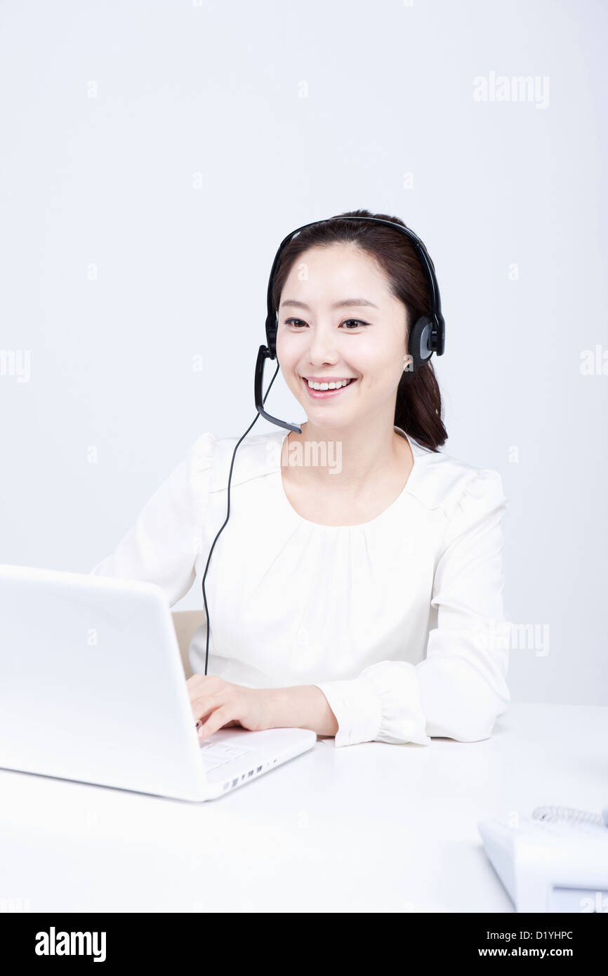 a telemarketer smiling while working Stock Photo - Alamy