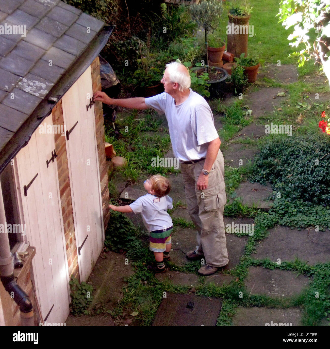 grandfather outside by a shed with grandson Stock Photo - Alamy