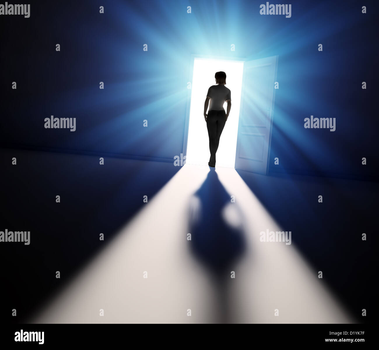 A woman walking into the light through open door Stock Photo - Alamy