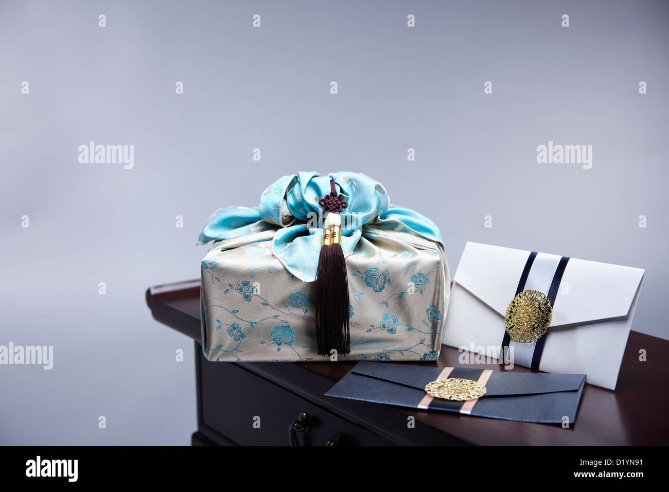 a package in Korean traditional wrap and envelopes on traditional table ...