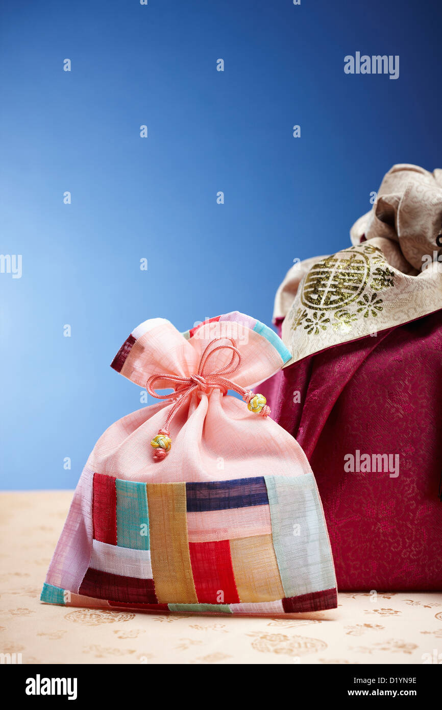 Korean traditional luck pocket in front of a package in a red Korean ...