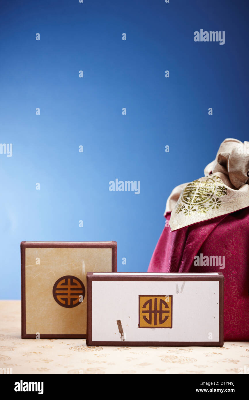 Korean traditional boxes in front of a package in a red Korean ...