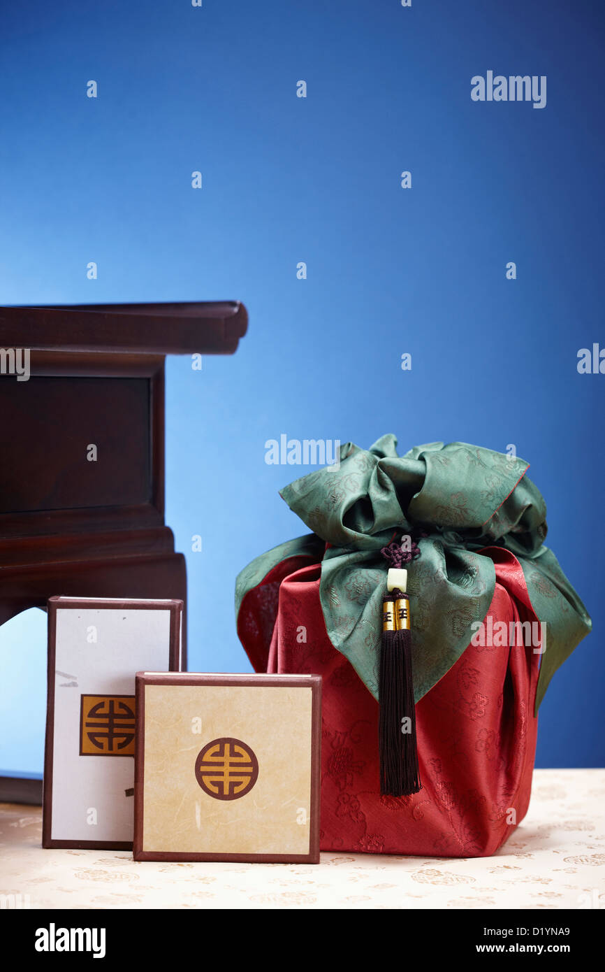 Korean boxes on the floor with a package in Korean traditional wrap ...