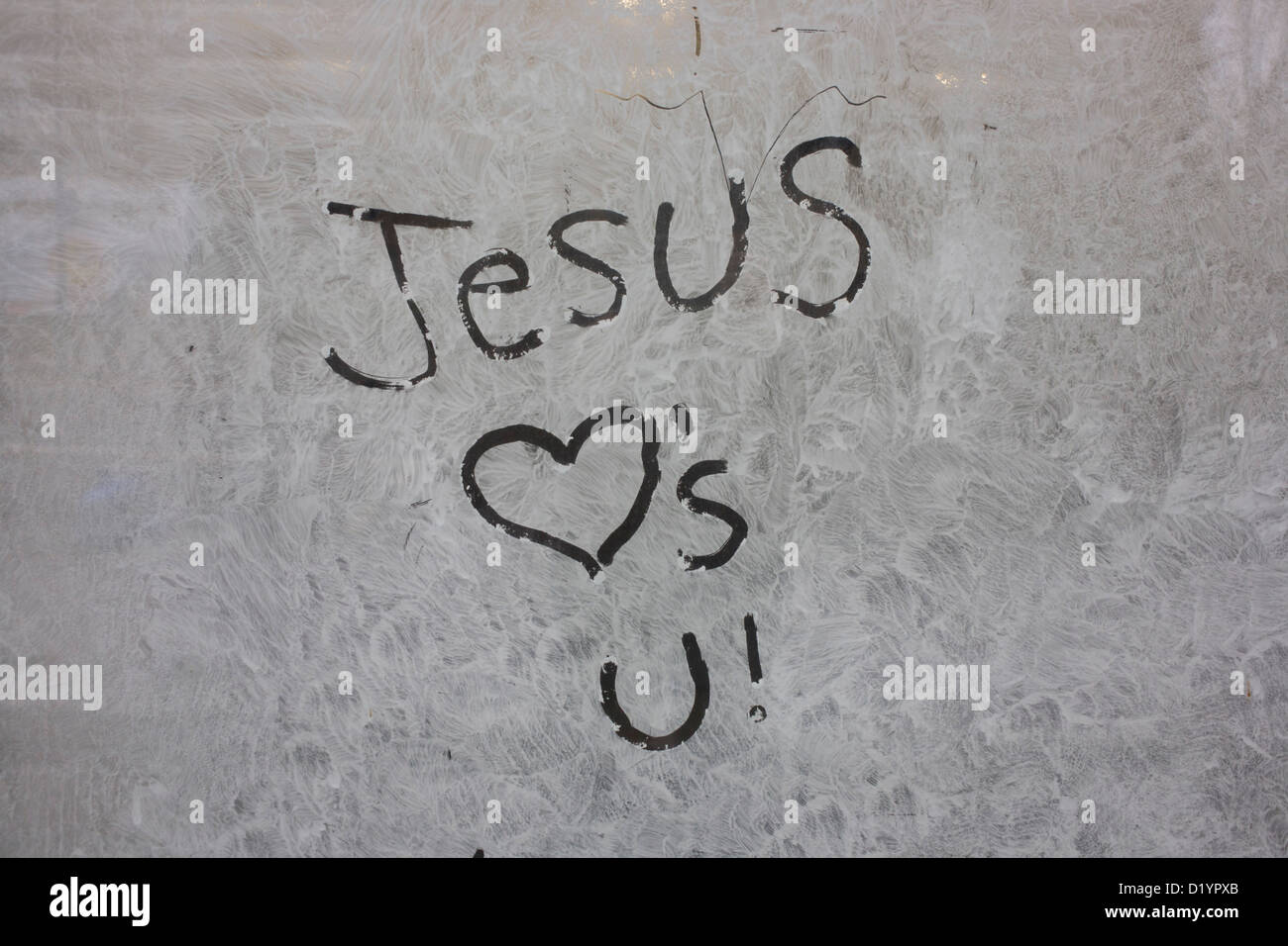 'Jesus Loves (heart) You' handwritten on an opaque window, swirled with ...