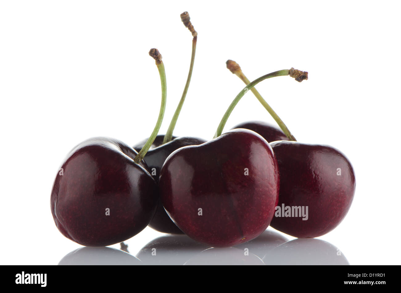 Red cherries on white reflective background Stock Photo - Alamy