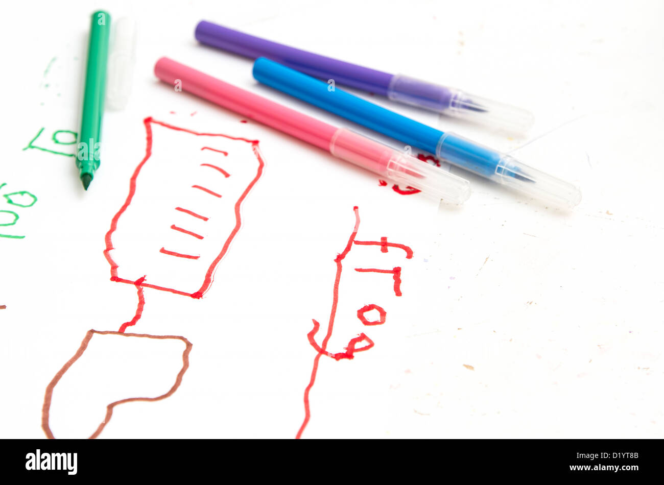 Young child's drawing and writing on white paper with color pens Stock ...